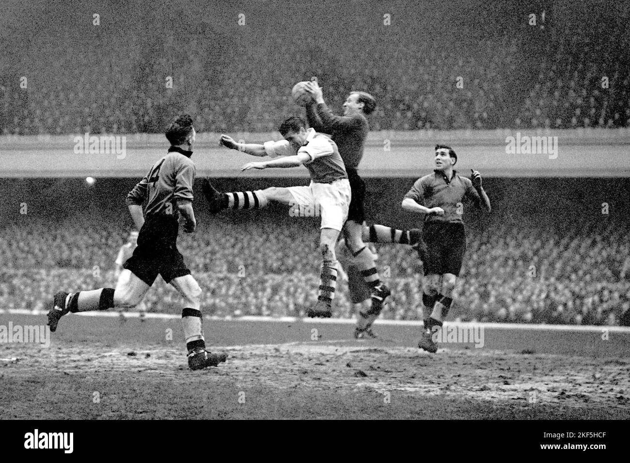 Wolverhampton Wanderers goalkeeper Bert Williams (second r) catches the ...