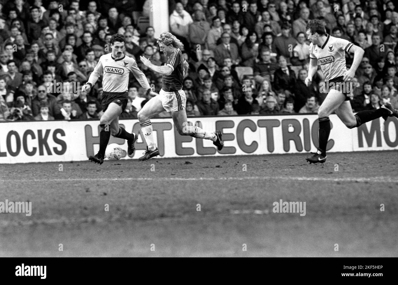 West Ham United's Frank McAvennie (c) takes on Oxford United's John ...