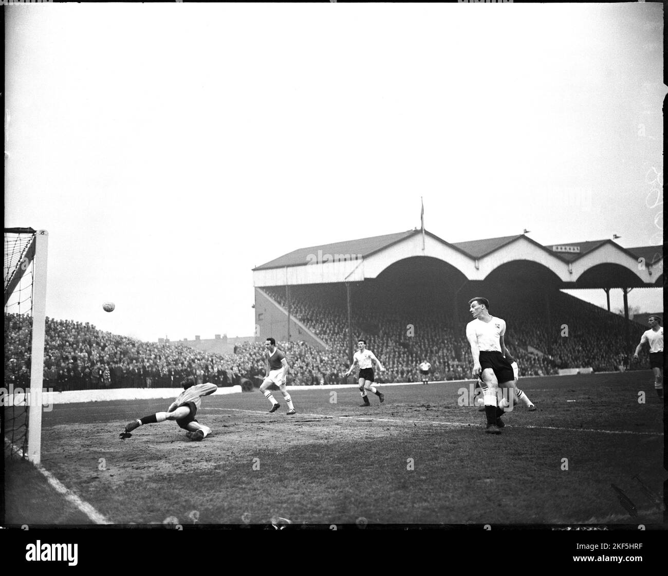 Derby County goalkeeper Reg Matthews (l) pushes a shot from Charlton ...