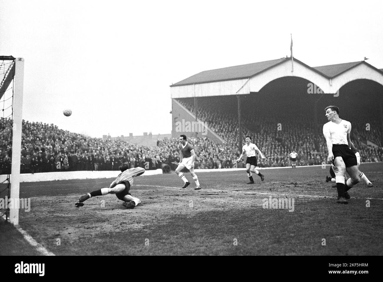 Derby County goalkeeper Reg Matthews (l) pushes a shot from Charlton ...