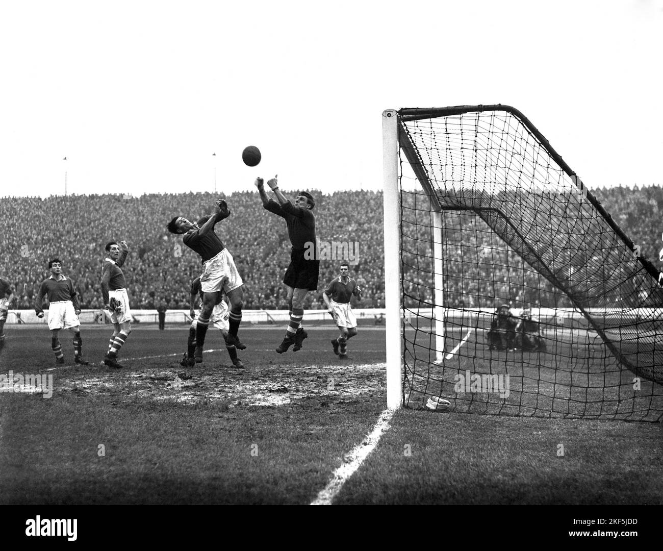 Liverpool goalkeeper Russell Crossley (r) punches clear from Chelsea's ...