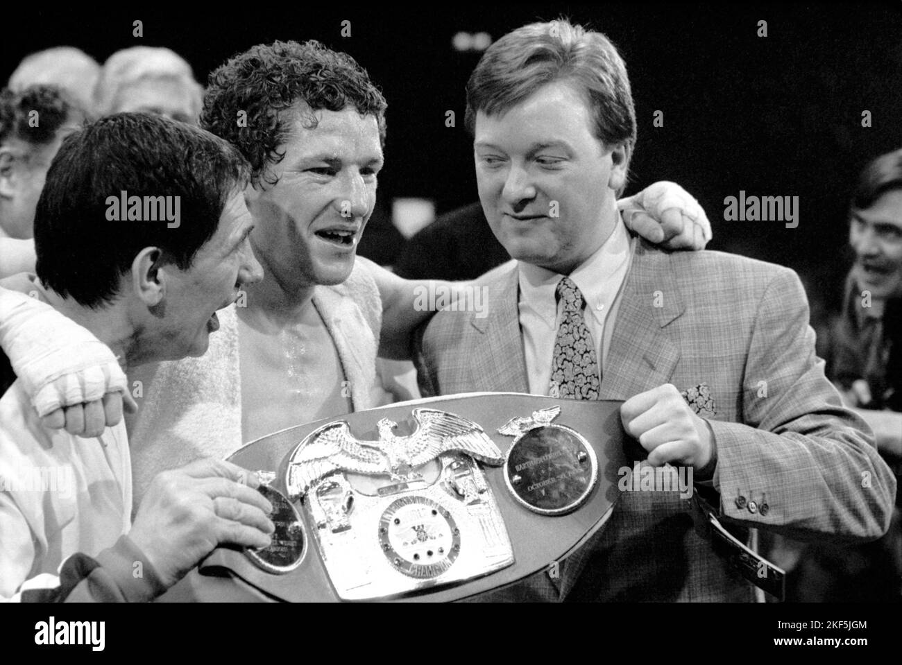 Terry Marsh (c) and promoter Frank Warren (r) celebrate with the belt ...