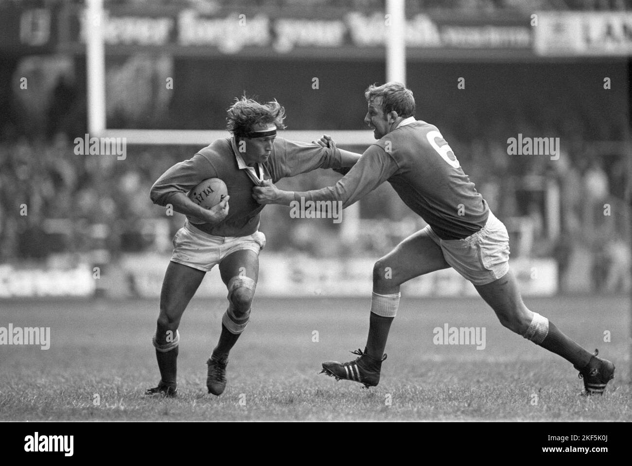(L-R) President's XV's Roger Gould is tackled by Wales' Richard ...