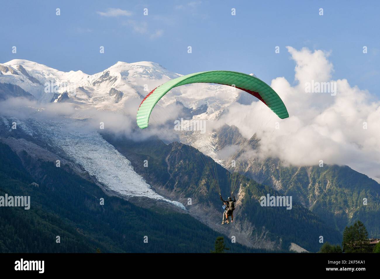 Tandem paragliding with the Mont Blanc massif in the background in summer, Chamonix, Haute ...
