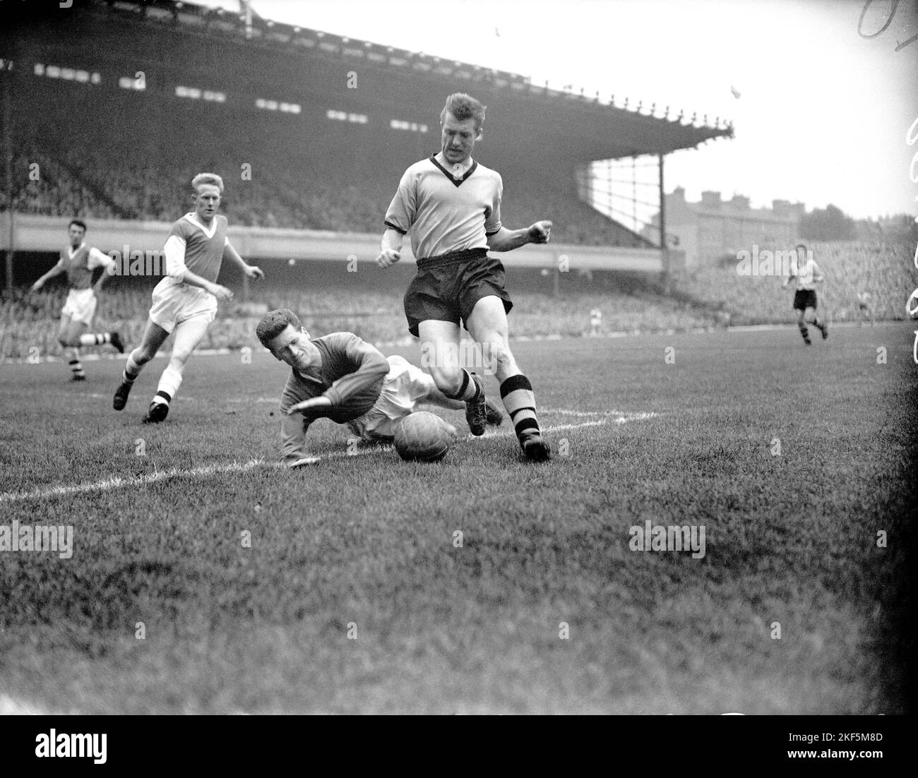 (L-R) Arsenal goalkeeper Jim Standen dives at the feet of Wolverhampton ...