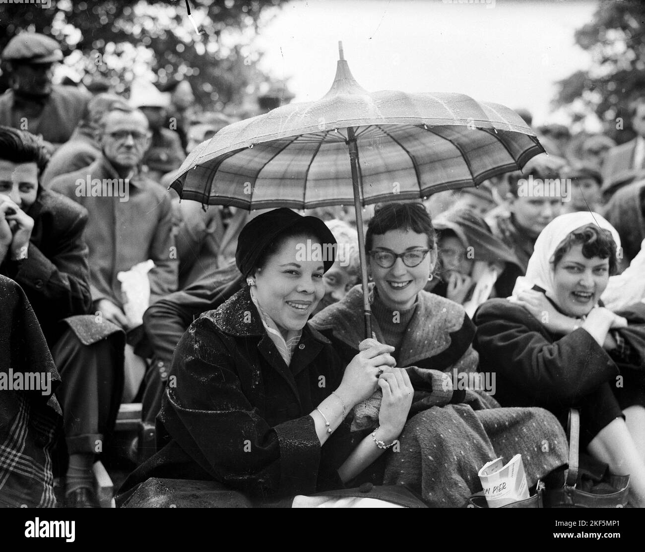 A West Indian lady shelters under her umbrella during a rainy spell ...