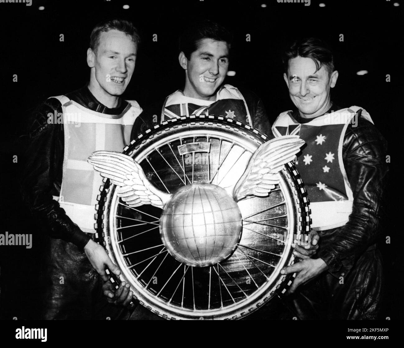 World Champion Barry Briggs (c) shows off the World Championship trophy ...