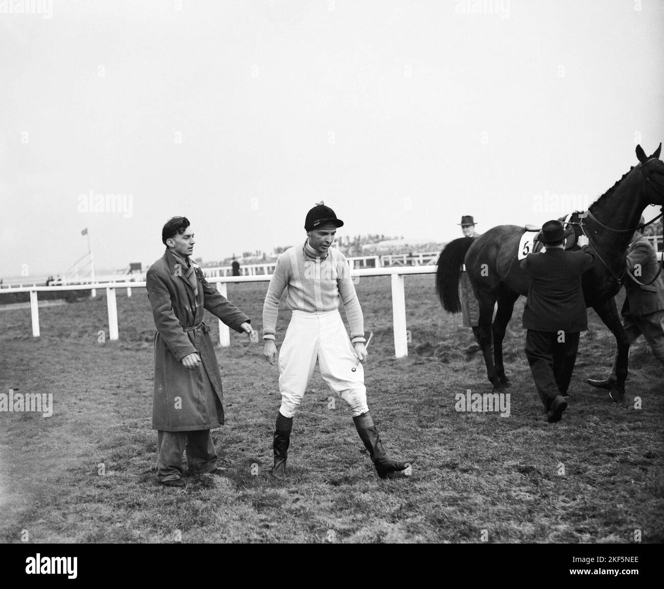 Dejected jockey Dick Francis is led away after his horse (owned by ...