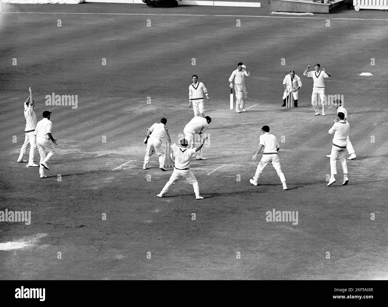 South Africa wicketkeeper Denis Lindsay (third l) whips off the bails ...