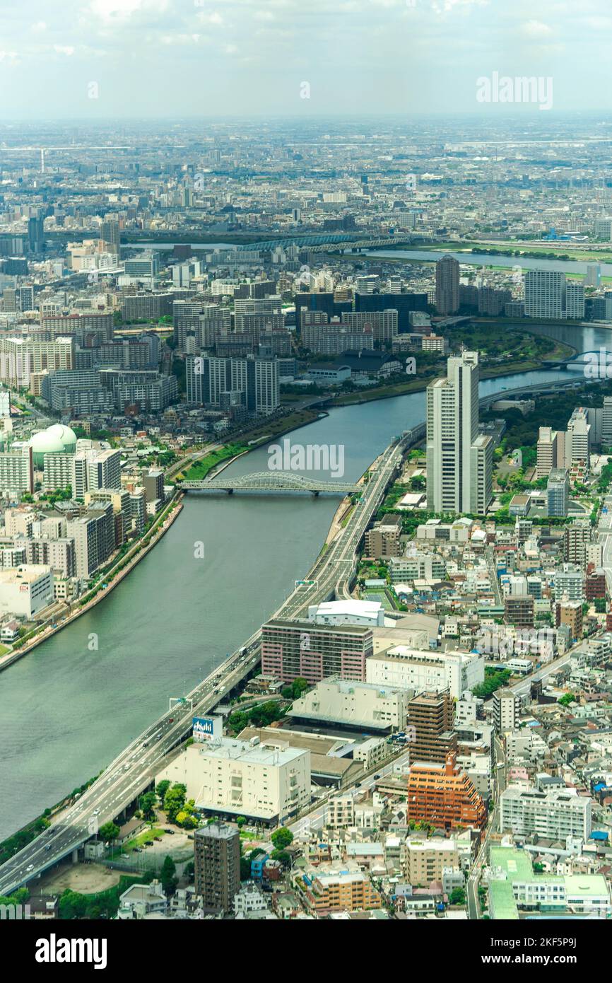 An aerial view of Shinano River flowing through Tokyo cityscape in ...