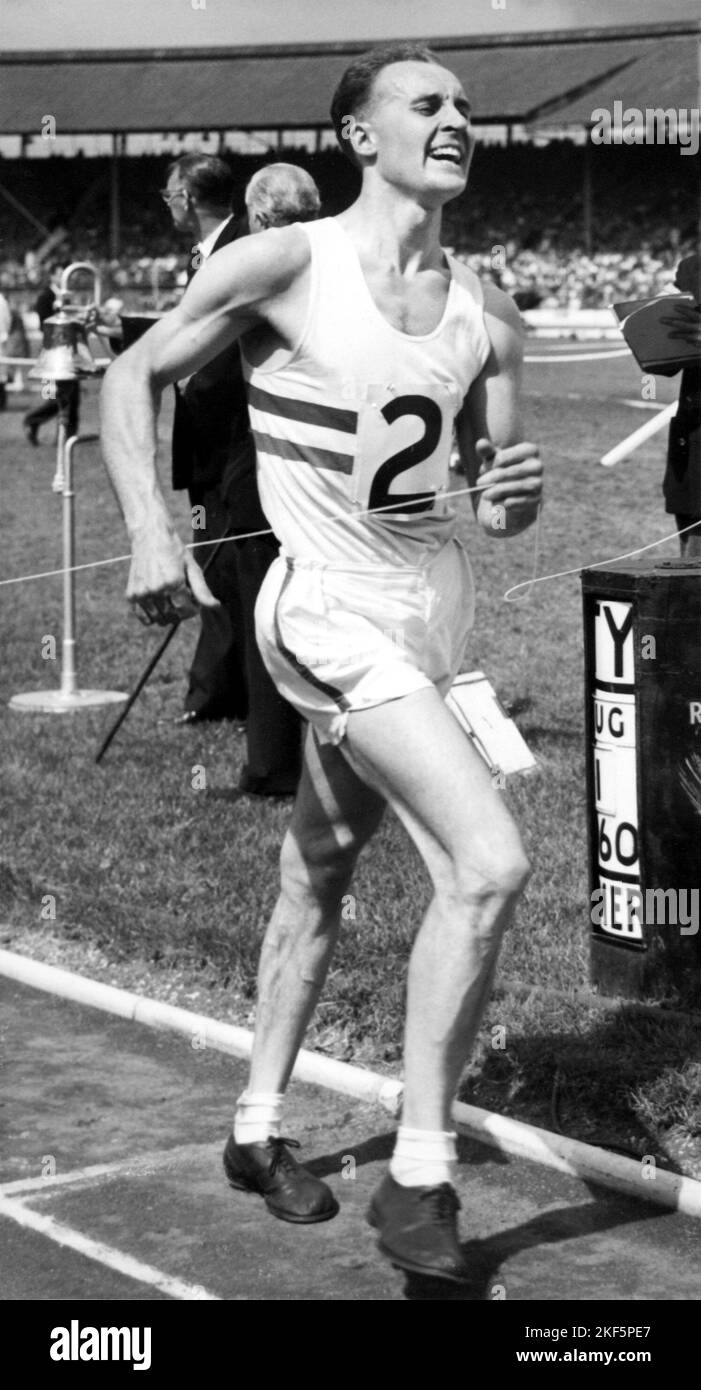 Great Britain's Ken Matthews manages a smile as he breaks the tape ...