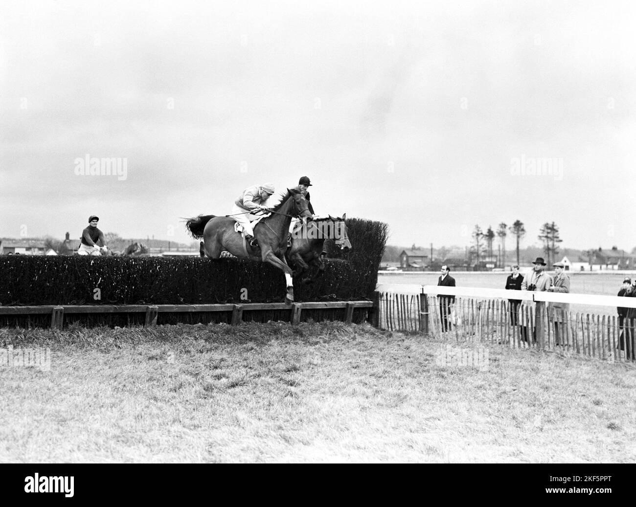 (L-R) Trapeze II, John Lawrence up, takes the last fence ahead of El ...