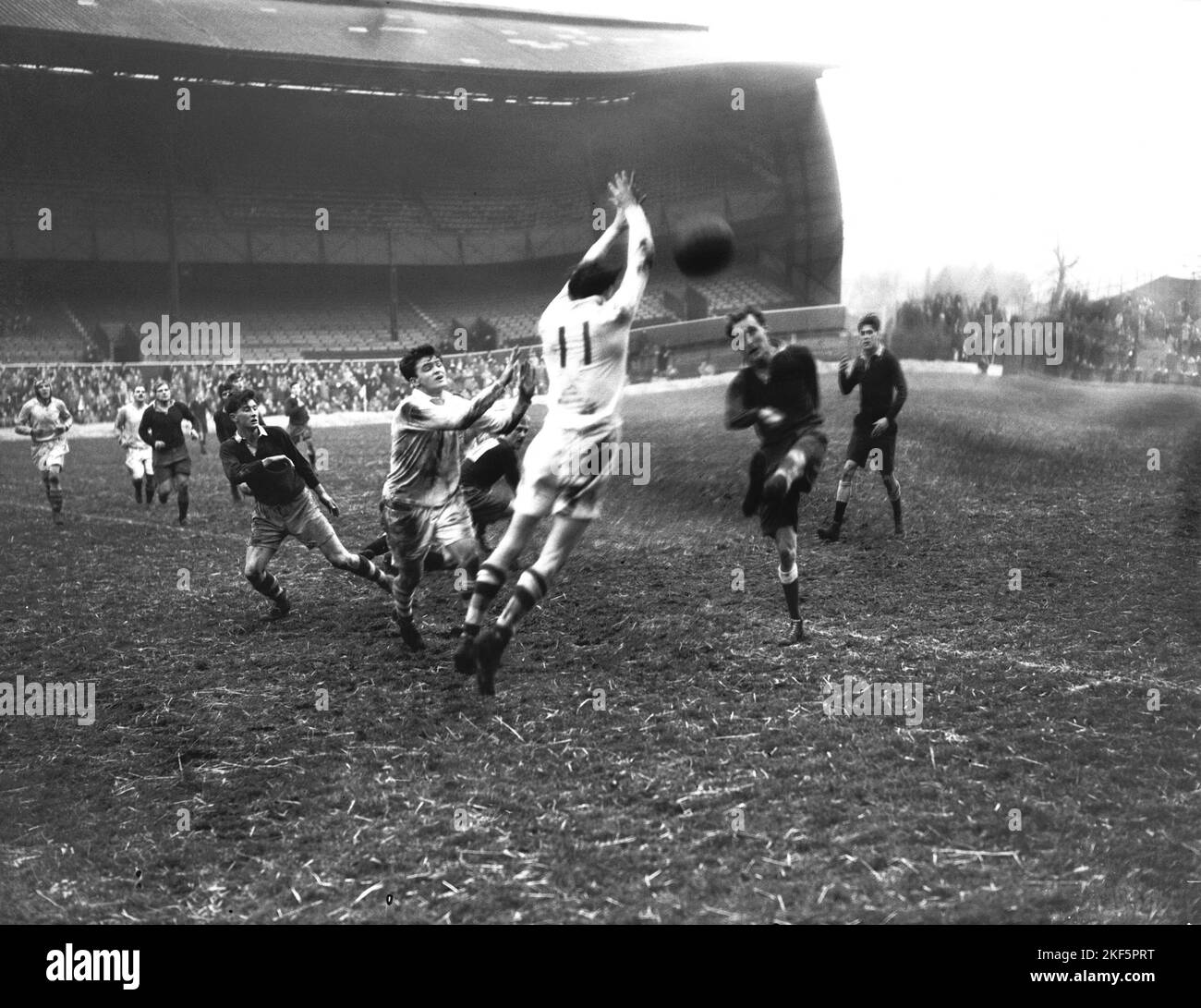 The Rest's Nim Hall (second r) kicks for touch as England's Frank Sykes ...