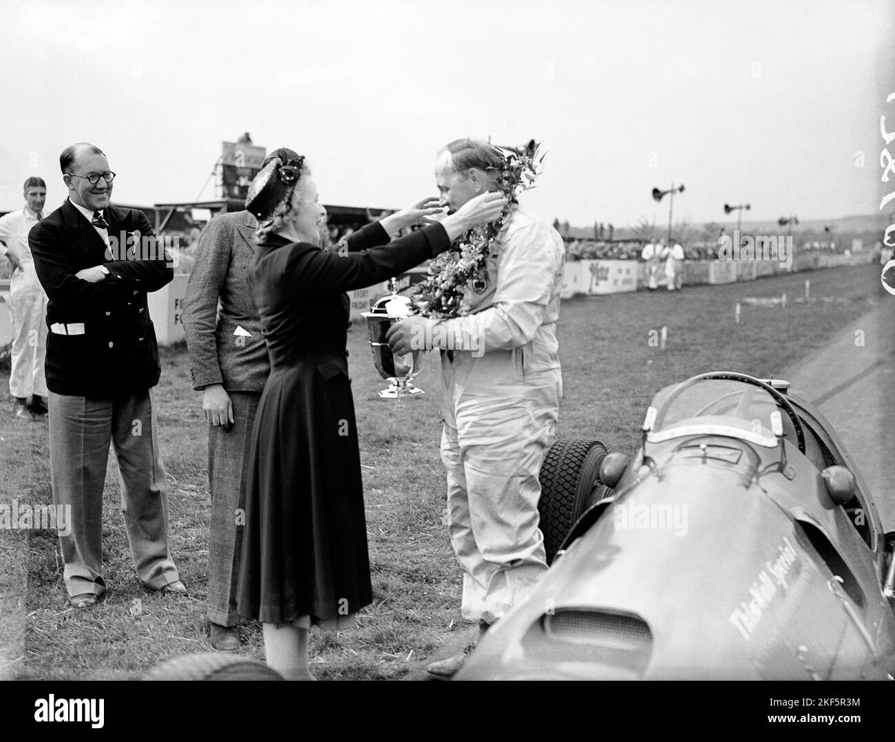 The Duchess of Richmond places a garland around the neck of Reg Parnell ...