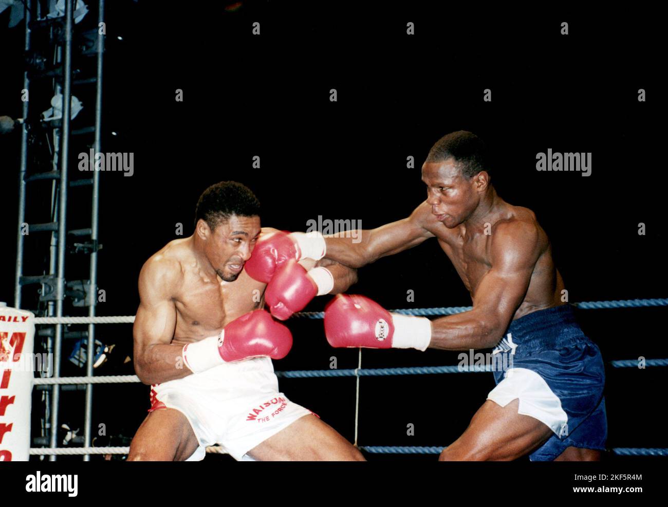 (L-R) Michael Watson feels the force of a combination from Chris Eubank ...