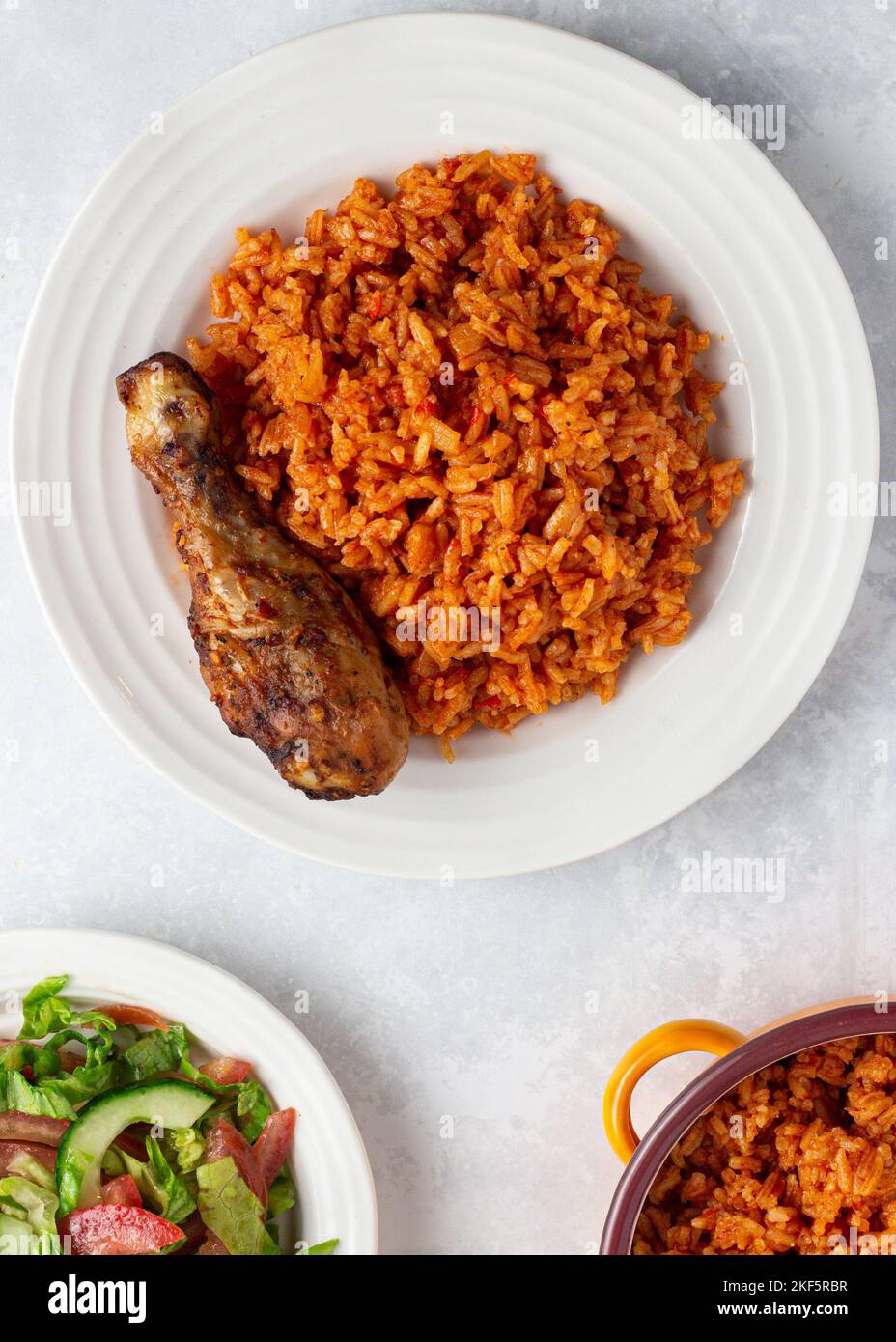 Jollof rice served with salad Stock Photo - Alamy