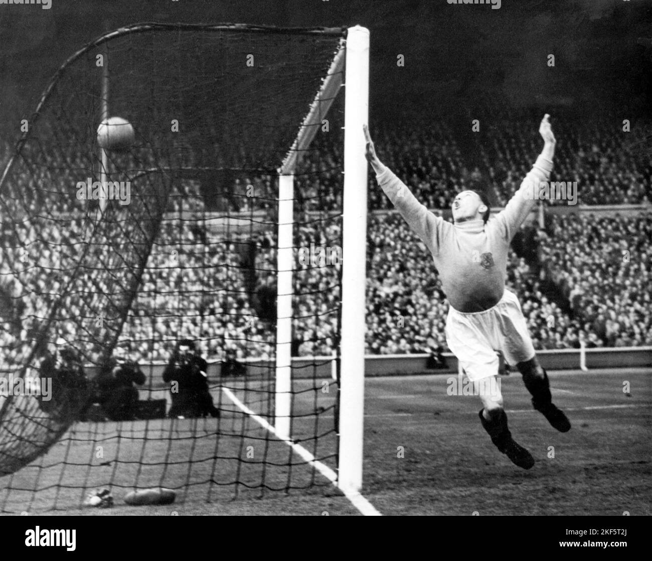 Scotland goalkeeper Tom Cowan is beaten for England's first goal Stock ...