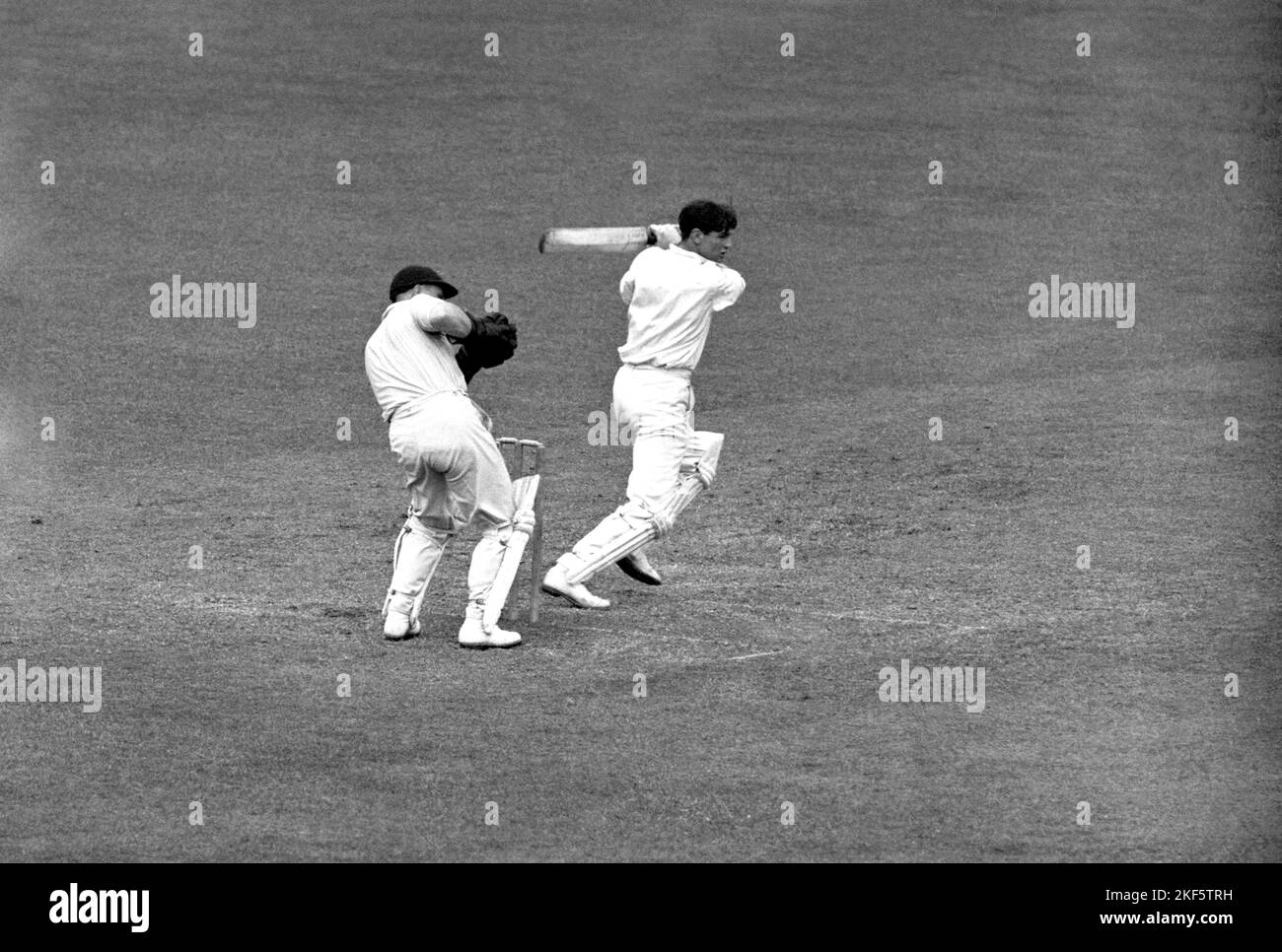 Australian Services' Keith Miller (r) batting, watched by England ...