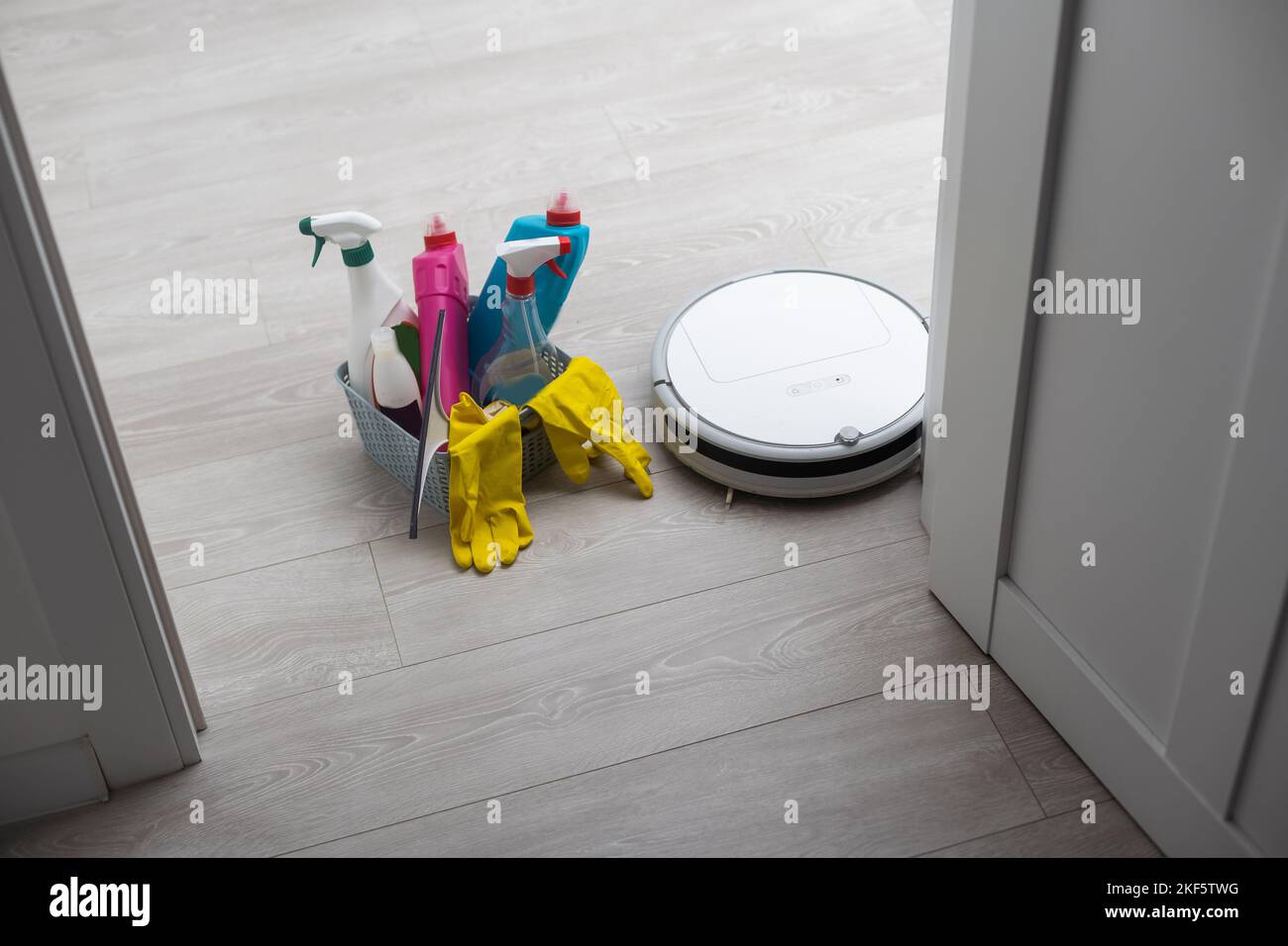 modern home cleaning products. Robot vacuum cleaner, cleaning sponges ...