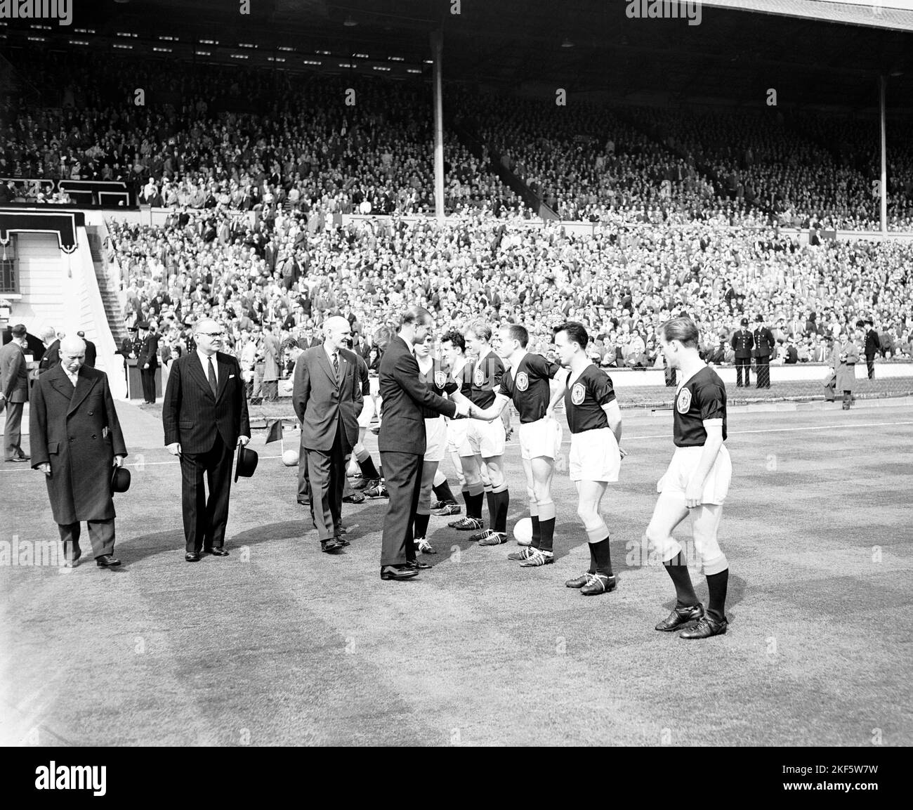 HRH The Duke of Edinburgh (c) shakes hands with Scotland's Ian St John ...