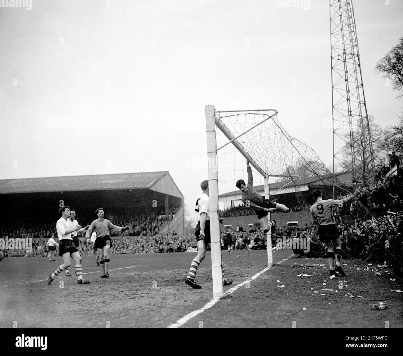 Preston North End goalkeeper Alan Kelly (second r) hangs from the ...
