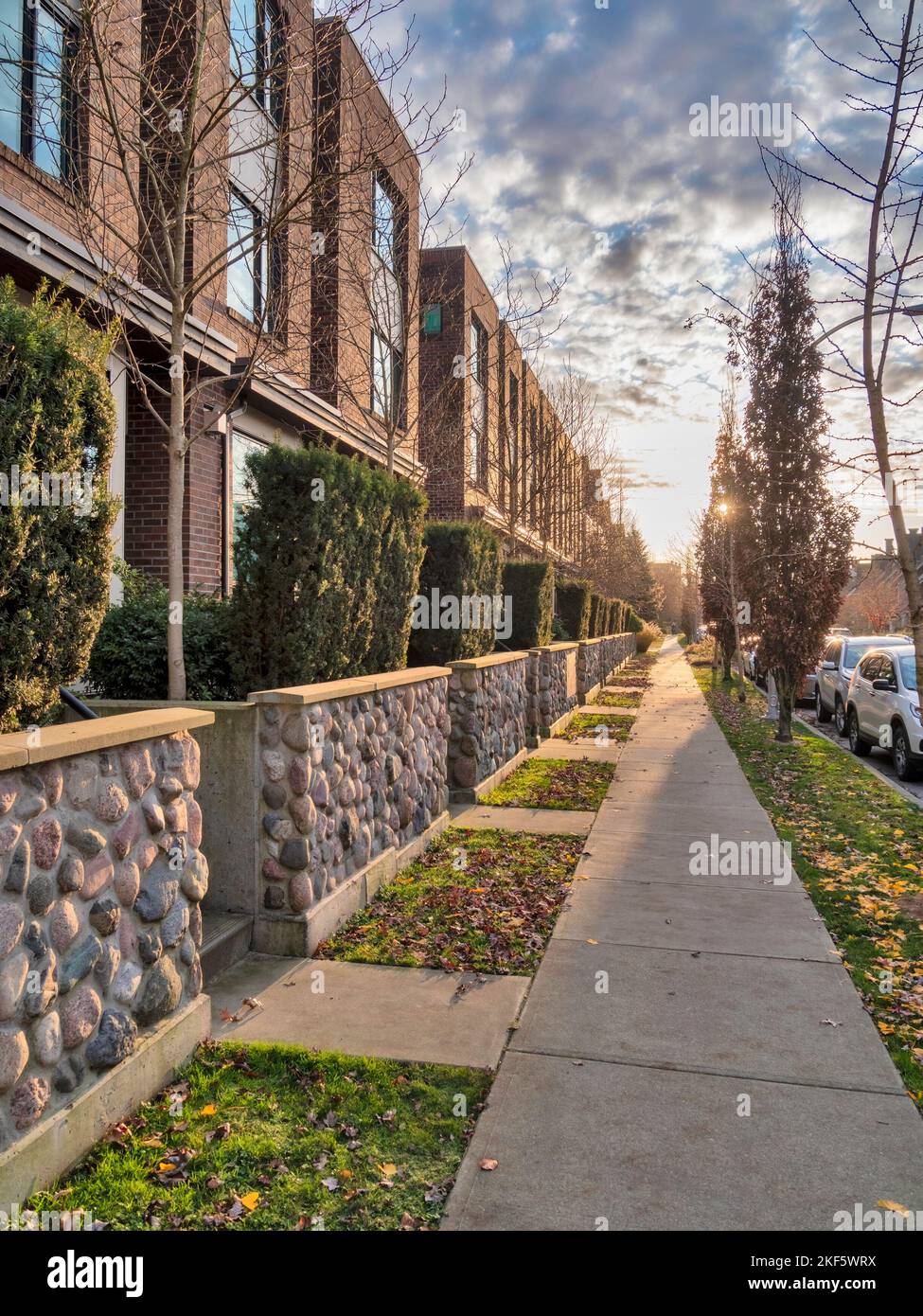 Sidewalk along townhouses on autumn season in Queensborough community ...