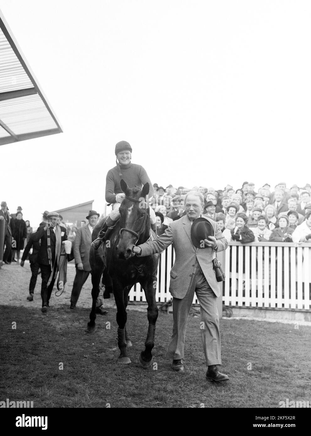 Woodland Venture, Terry Biddlecombe up, is led in by owner Harry ...