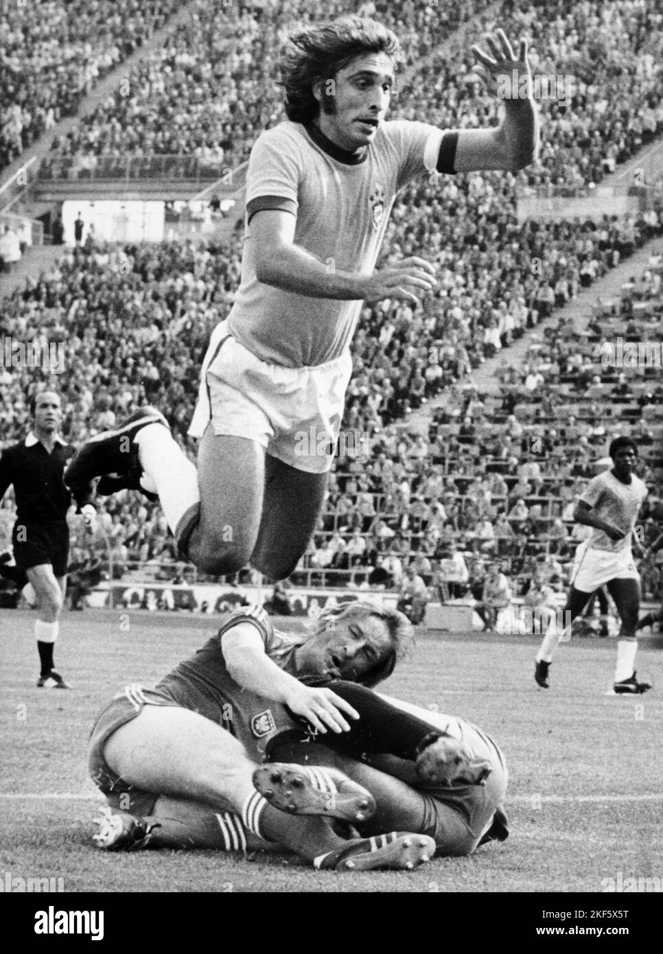 (L-R) Brazil's Mario Marinho flies over Poland's Andrzej Szarmach and ...