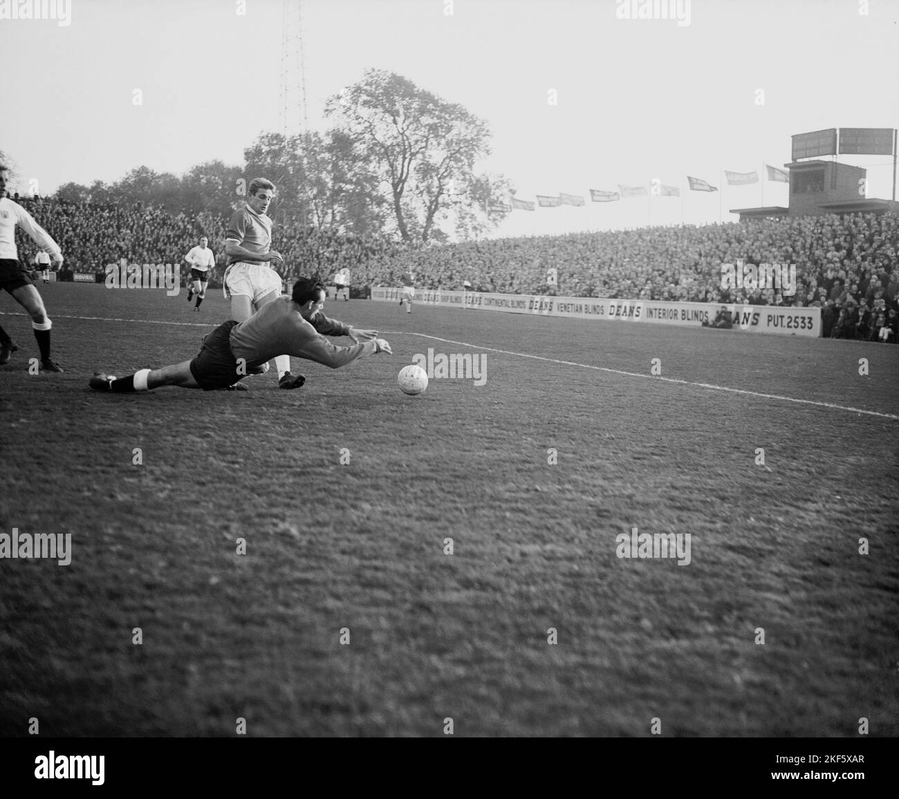 Fulham goalkeeper Tony Macedo dives at the feet of Liverpool's Roger ...
