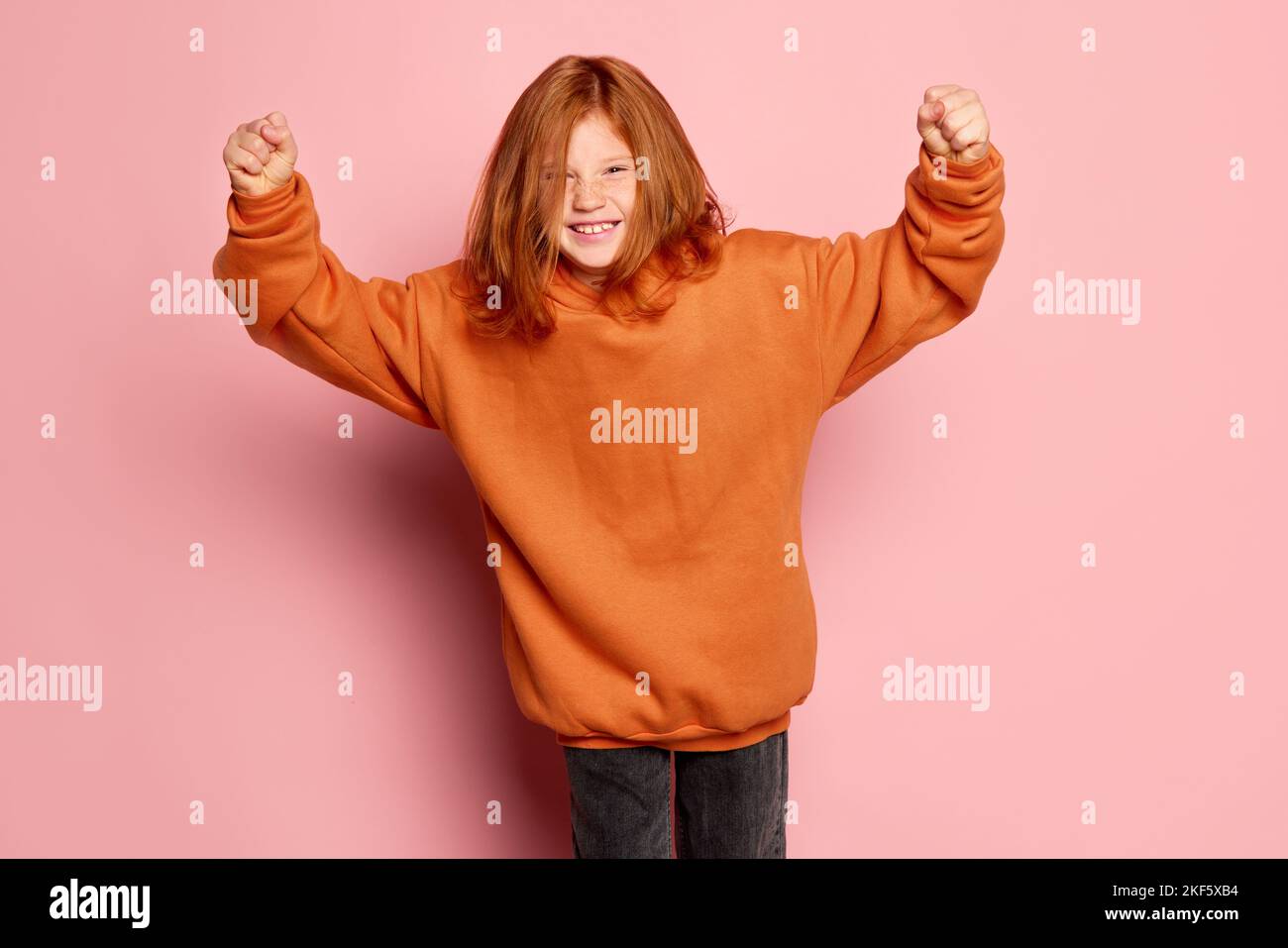 Expressive teen girl, modern kid with long red hair and freckles ...
