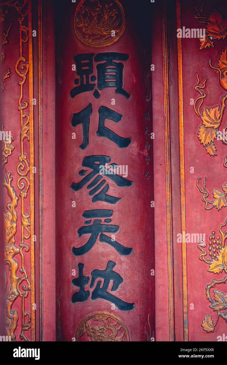 A vertical closeup shot of ancient Chinese writing in a Buddhist temple ...