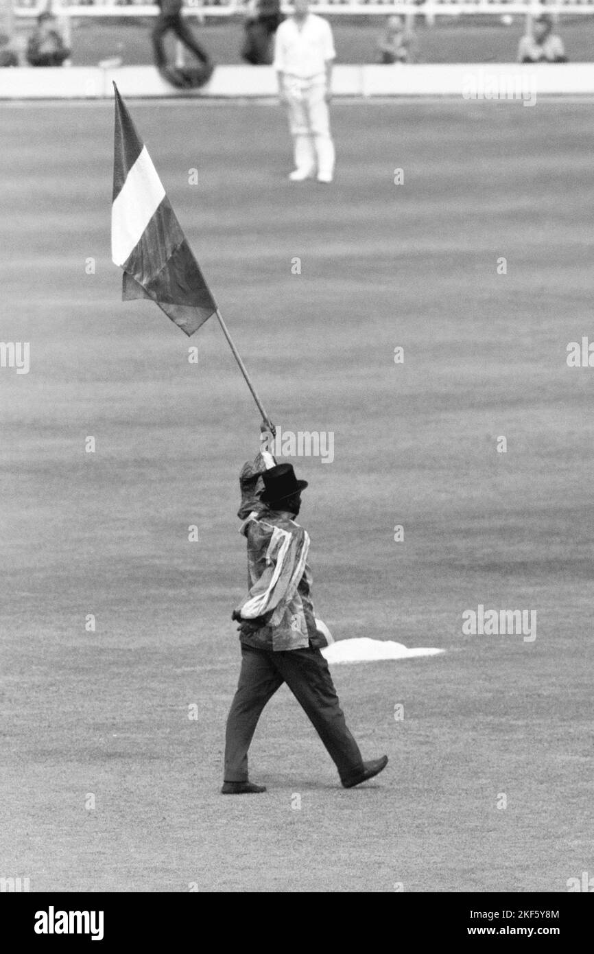 A West Indies fan parades the West Indian flag across the Lord's pitch ...