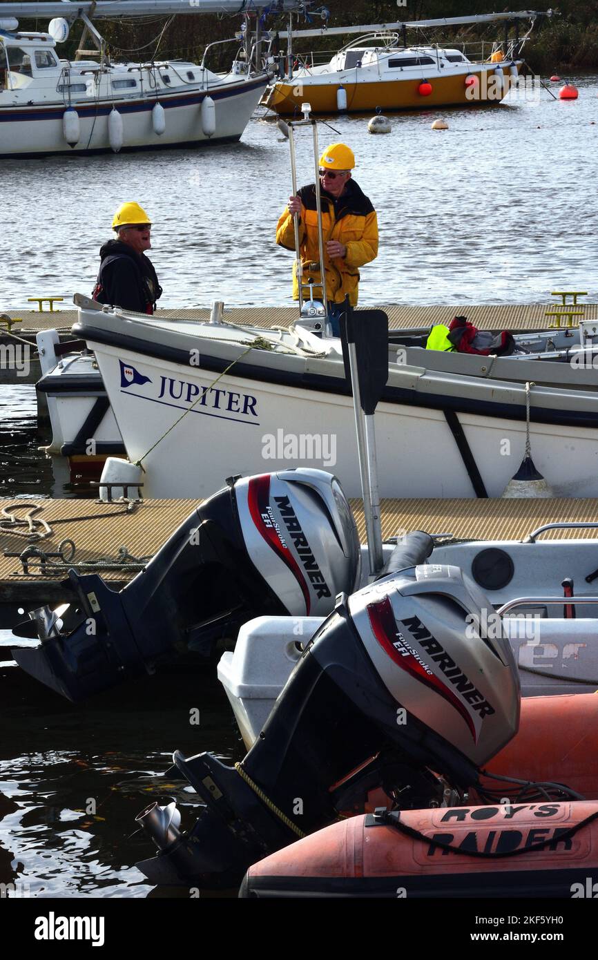 Riverside Boat Yard with outboard moaters and maintenance staff Stock ...