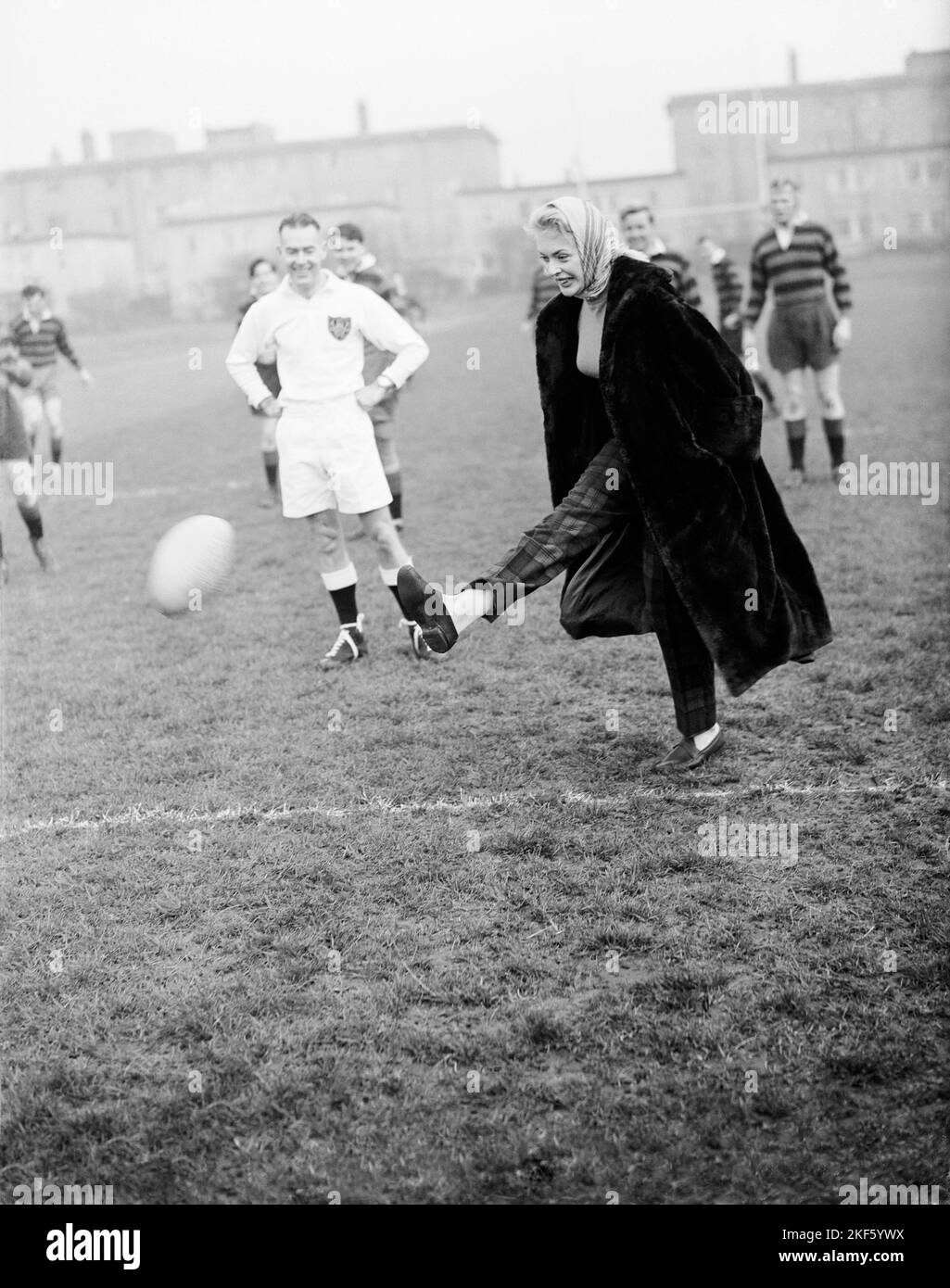 Italian actress Milly Vitale kicks off as players from both teams look ...