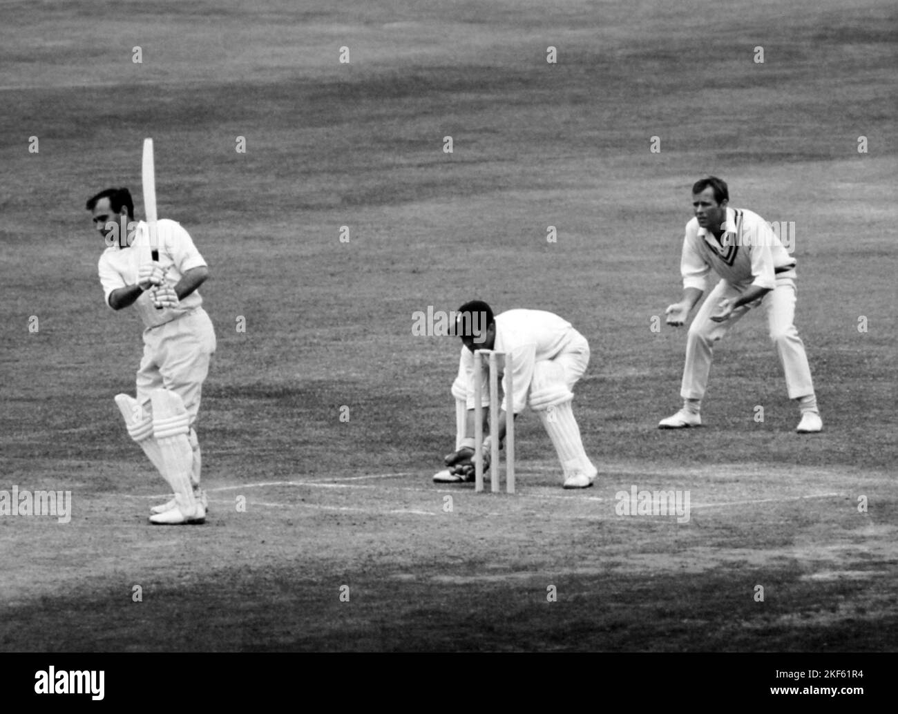 Middlesex's batsman Ronald William Hooker in action looked on by ...