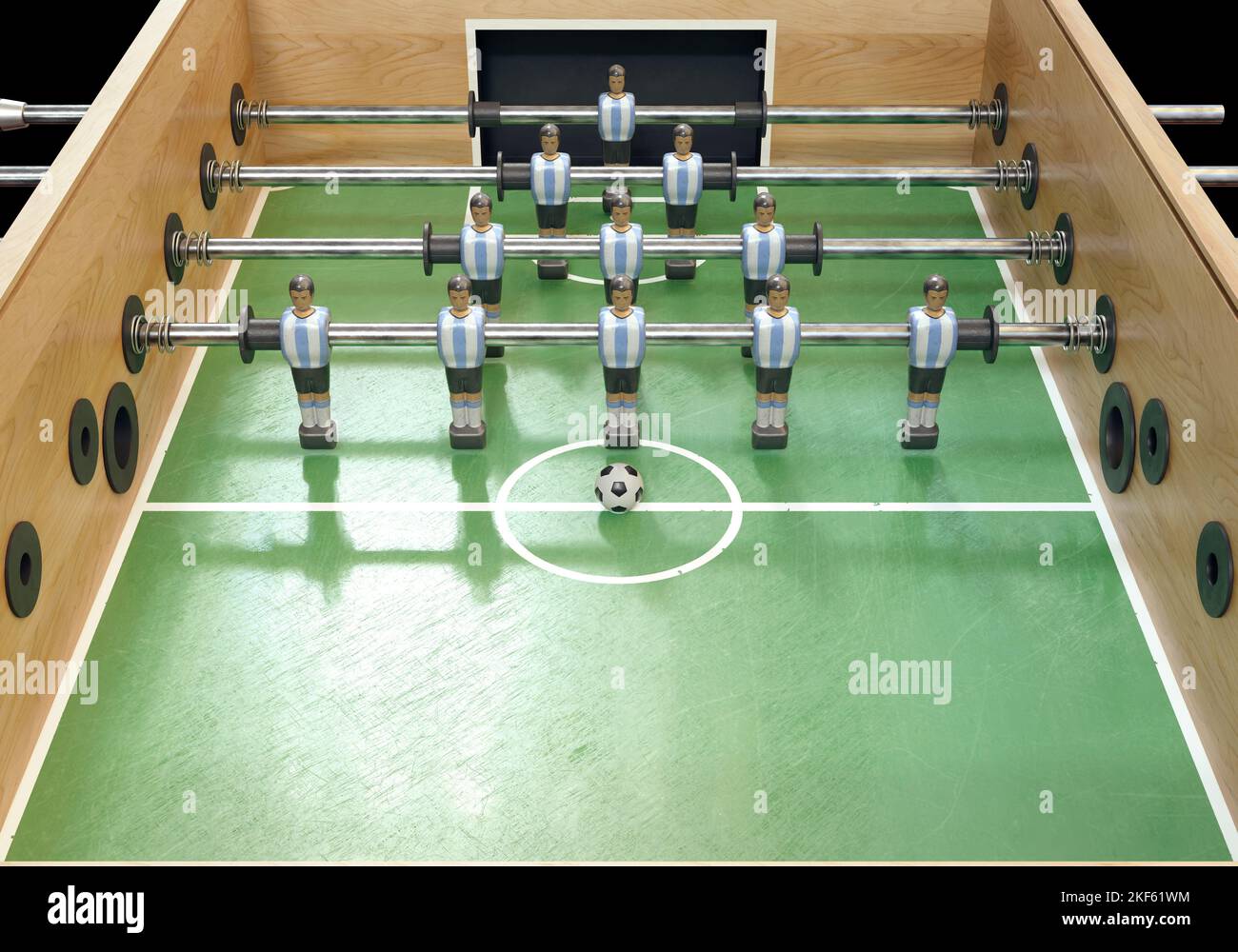 One side of a vintage foosball or table football table with worn metal ...