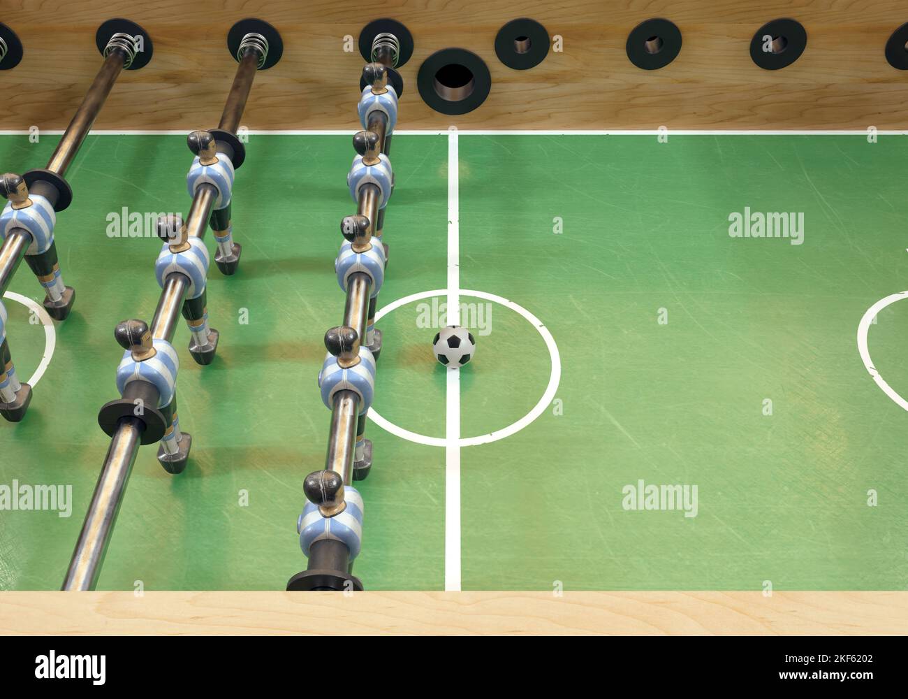 One side of a vintage foosball or table football table with worn metal ...