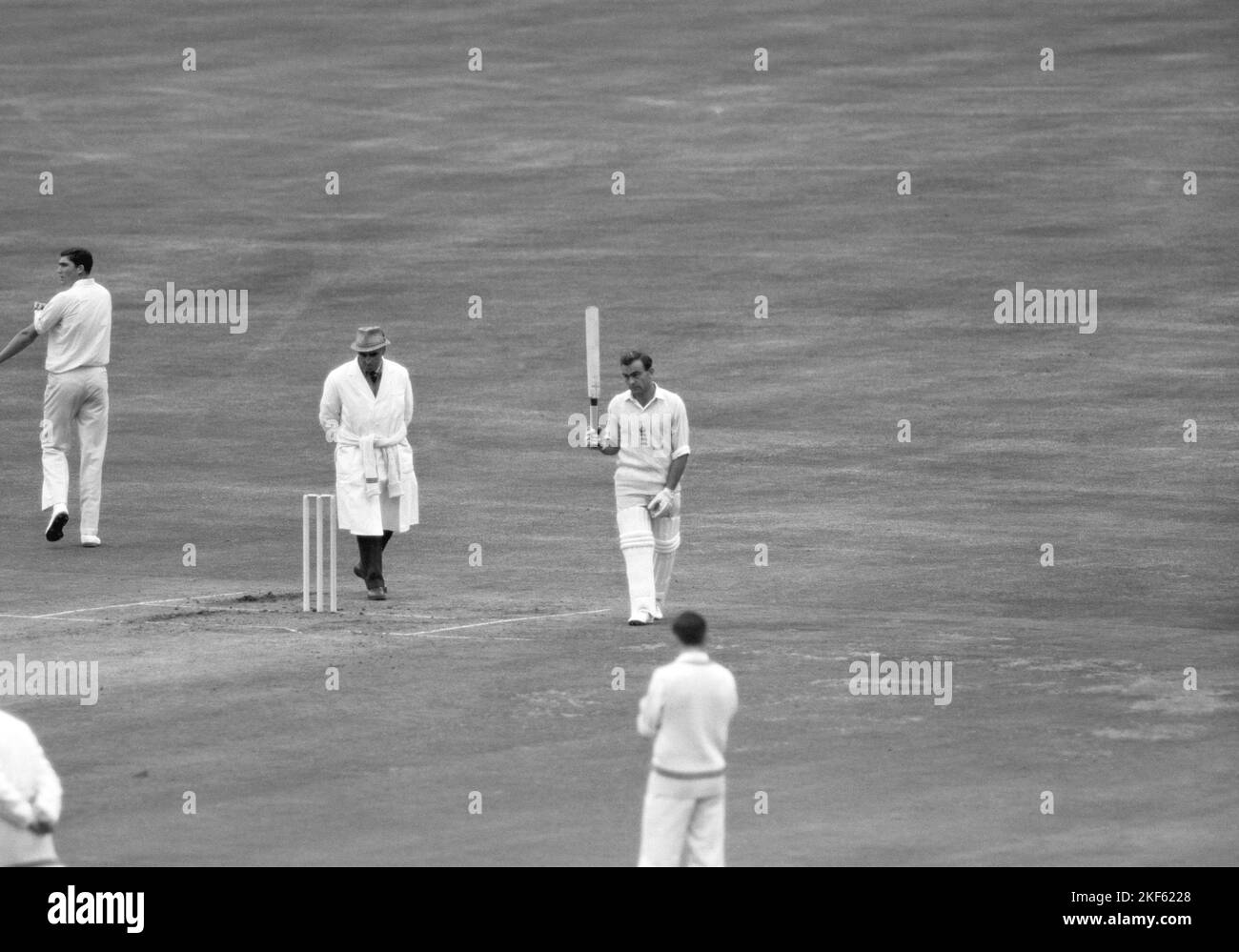 England's John Edrich lifts his bat in acknowledgement of the applause ...