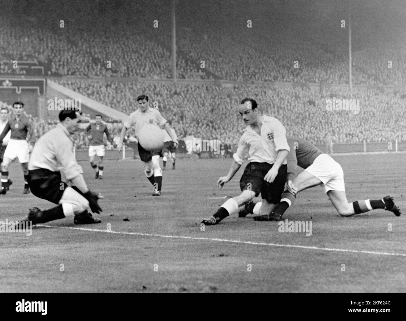 Gil Merrick, the England goalkeeper saves as Harry Johnston, England's ...