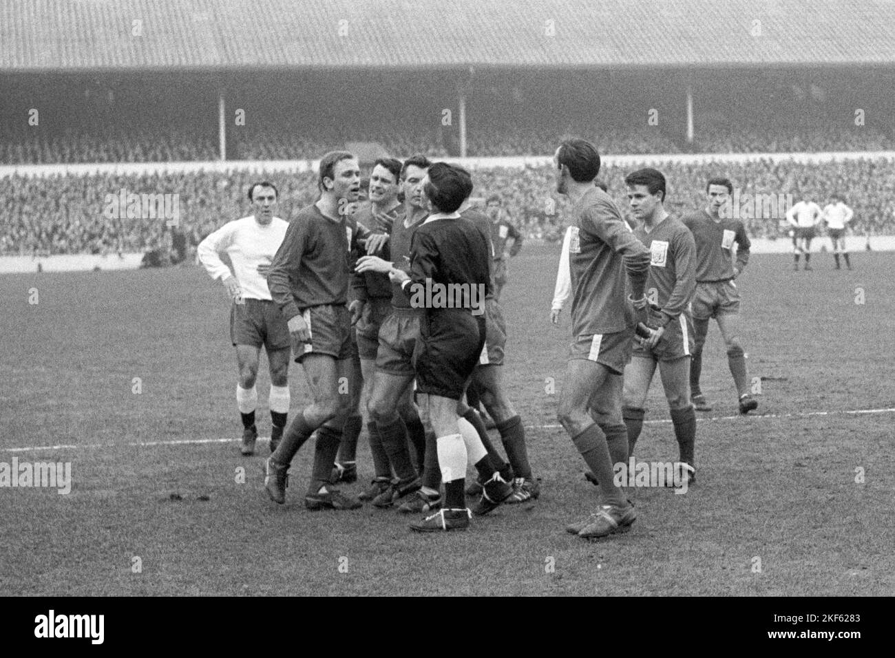 Bobby Robson and Johnny Haynes of Fulham try to break up the argument ...