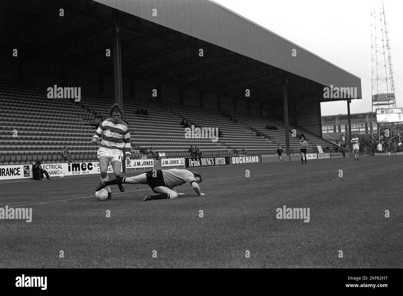 Don Givens, QPR, slips round the falling Don Beardsley to shoot for ...