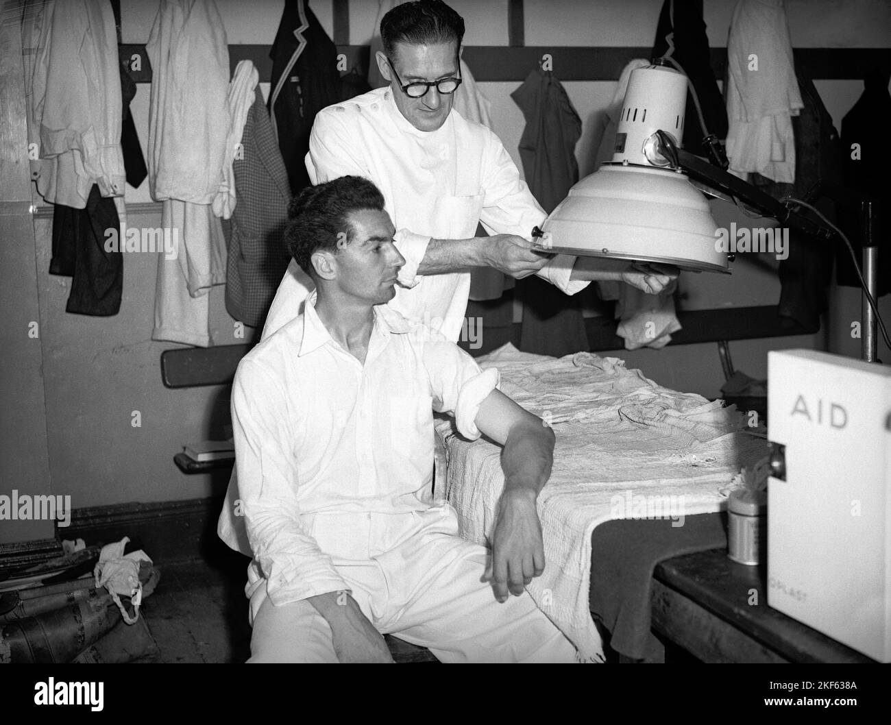 RT Simpson receiving treatment for his injured arm from Mr G Alcock ...