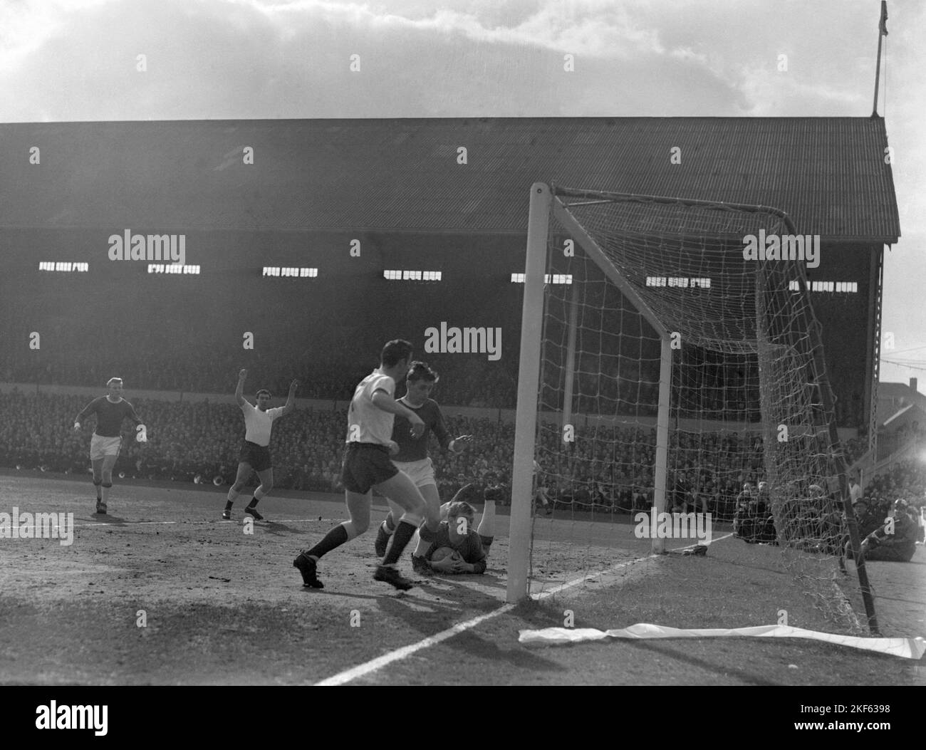 Cliff Jones of Spurs (left by goal) attempts to score as Mick Meagan ...