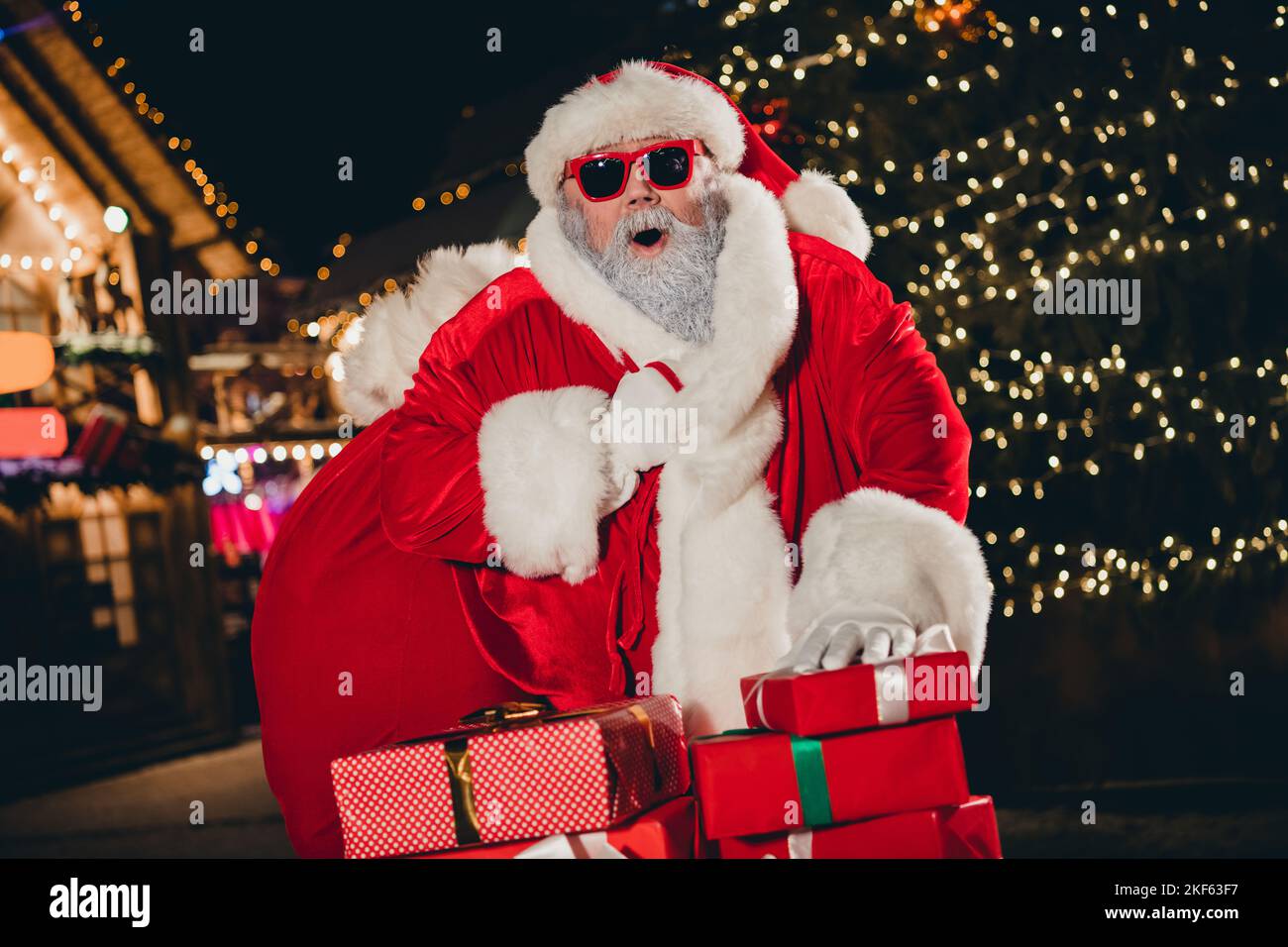Photo of funky excited astonished santa carry presents bag pile stack ...