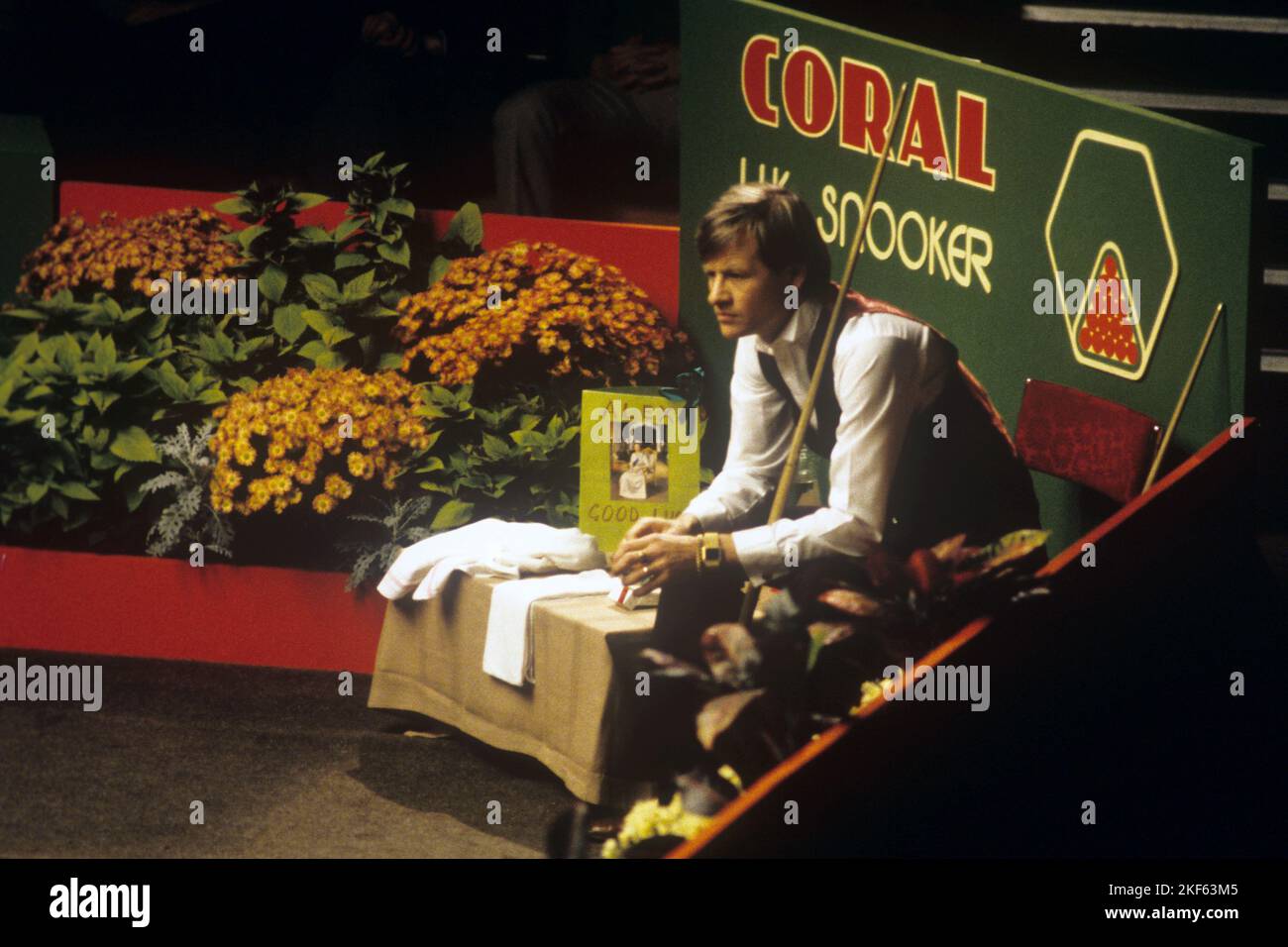 Alex Higgins during a break of play. On his table are a collection of ...