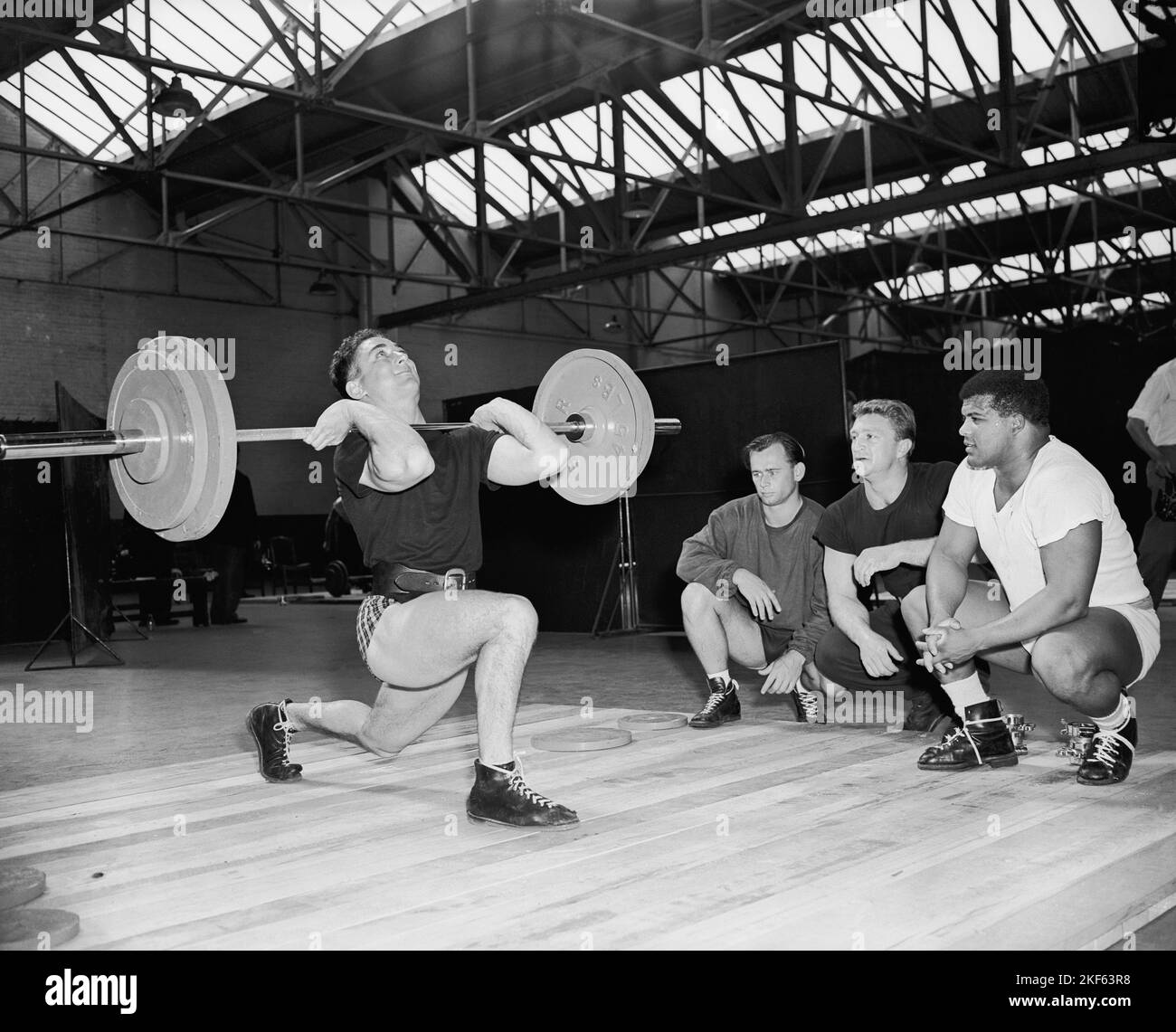 Australian weight lifters in training. Doryl Cohen, a middle weight ...