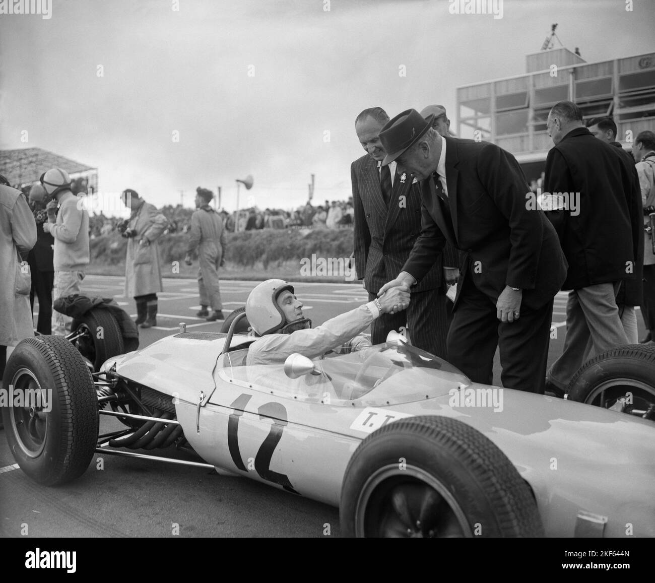 Earl Mountbatten of Burma shakes hands with racing driver Trevor Taylor ...