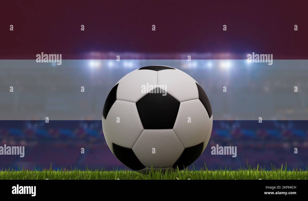 Soccer football ball on a grass pitch in front of stadium lights and ...