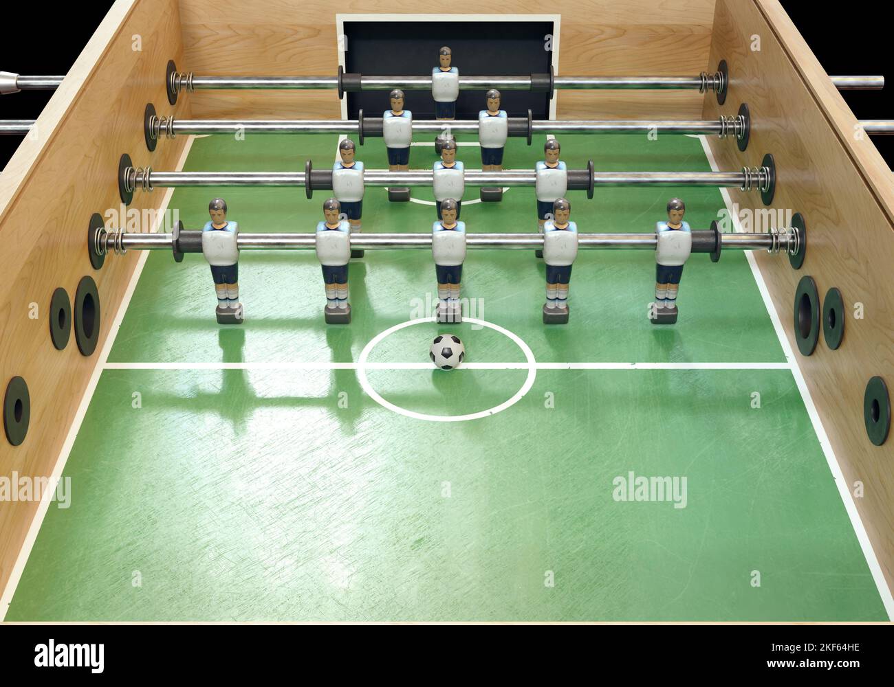 One side of a vintage foosball or table football table with worn metal ...