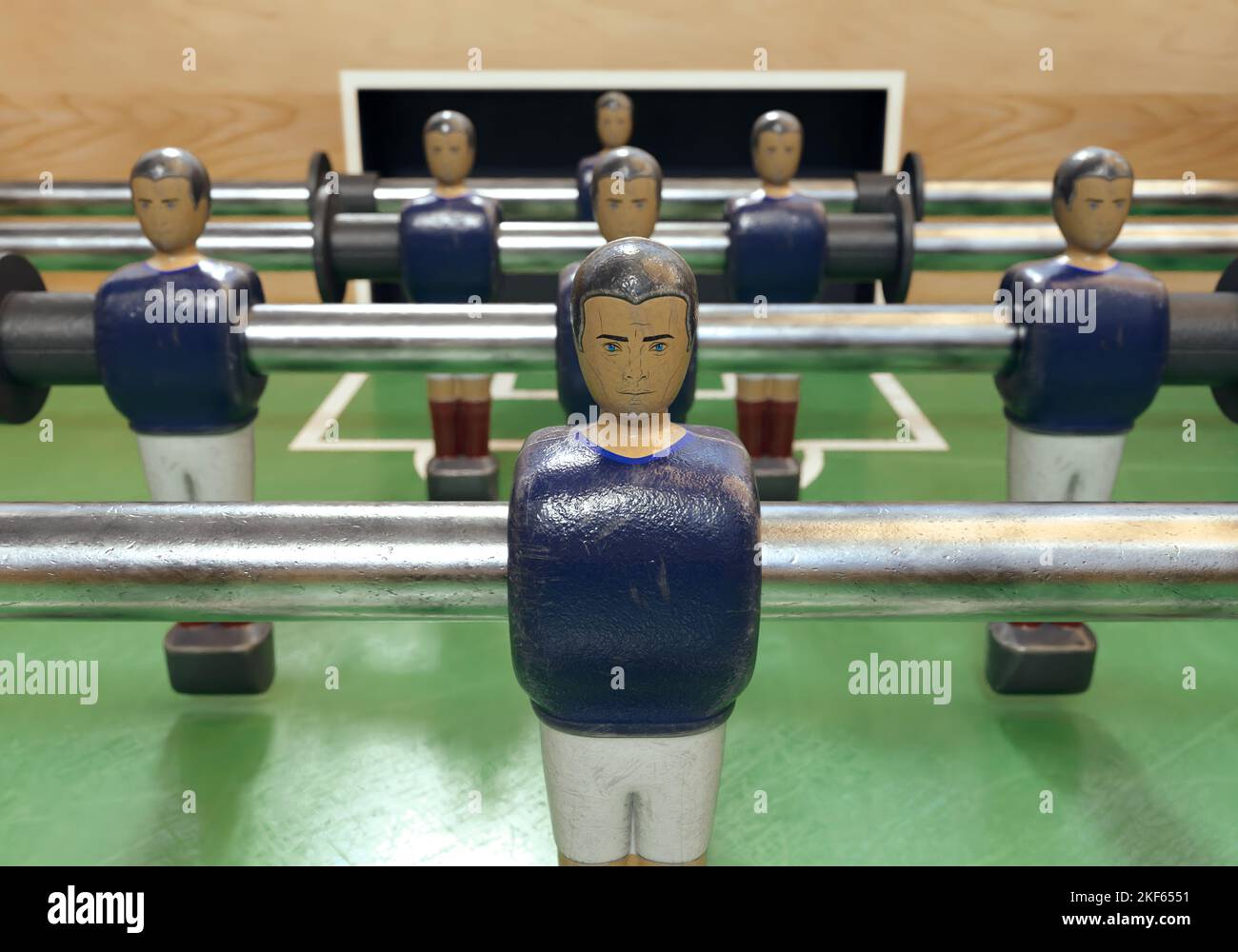 One side of a vintage foosball or table football table with worn metal ...